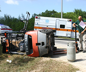 Forklift flips over with man inside - Cayman Compass