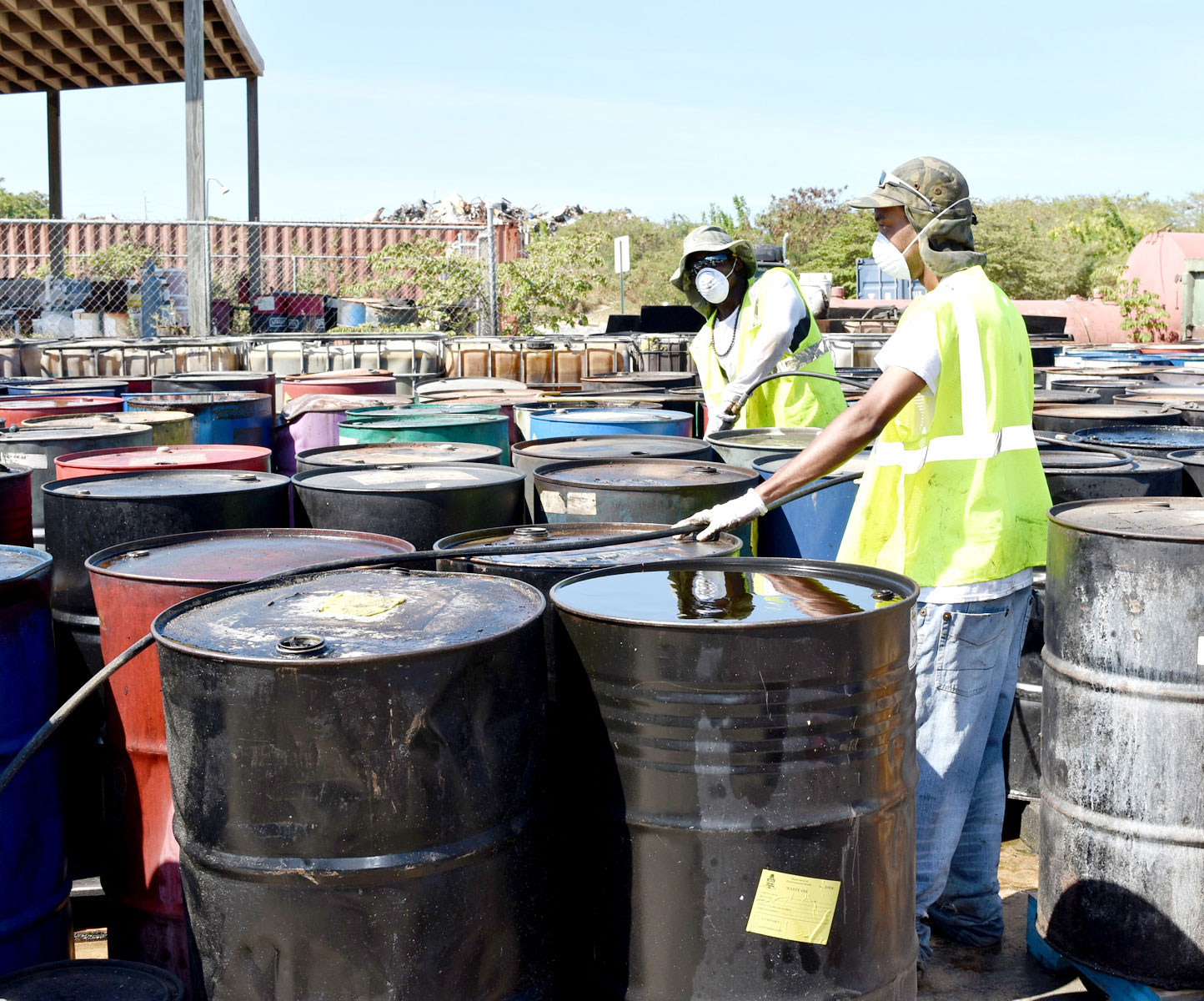 Seasonal workers clean up landfill - Cayman Compass