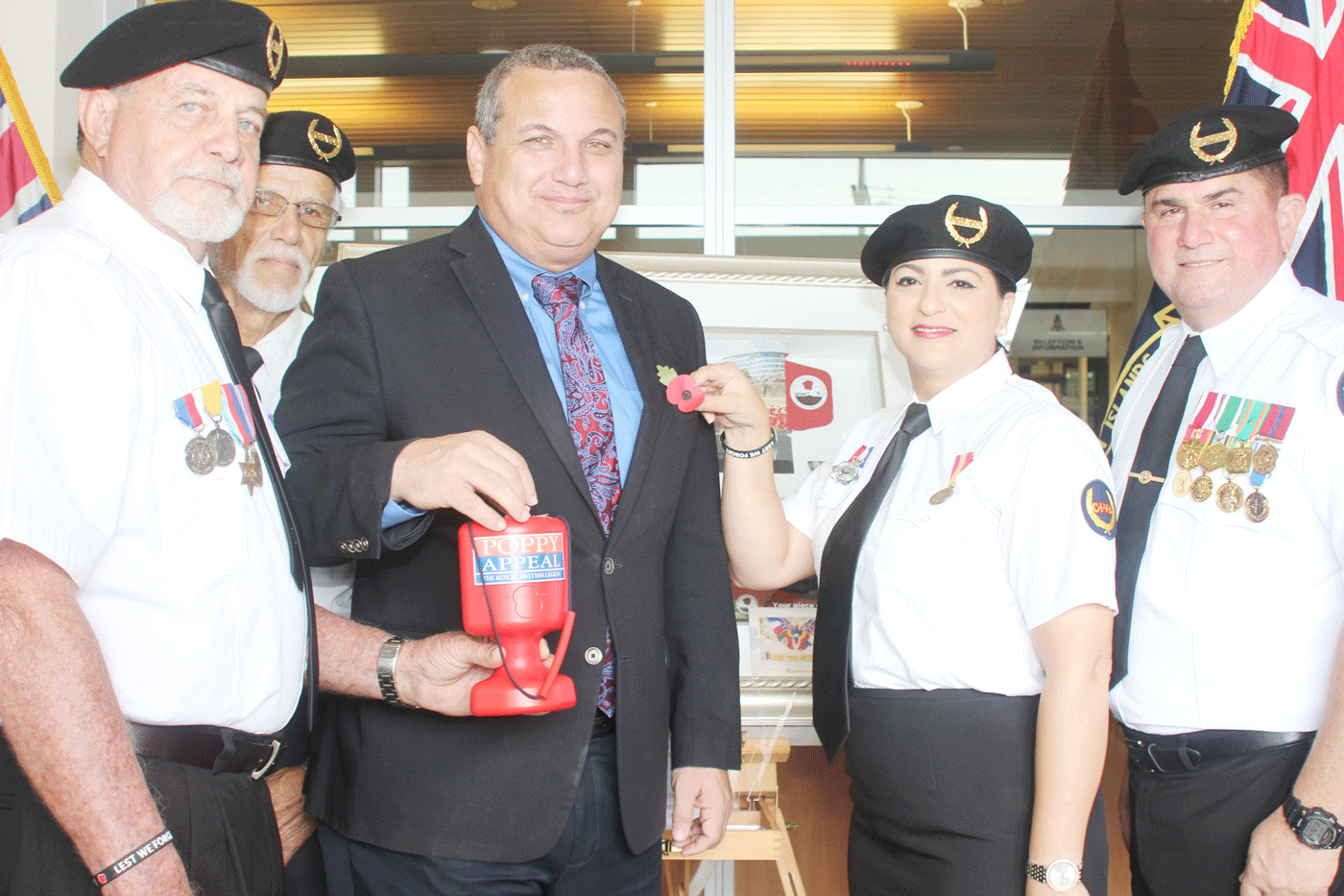 Acting Governor gets year’s first poppy - Cayman Compass