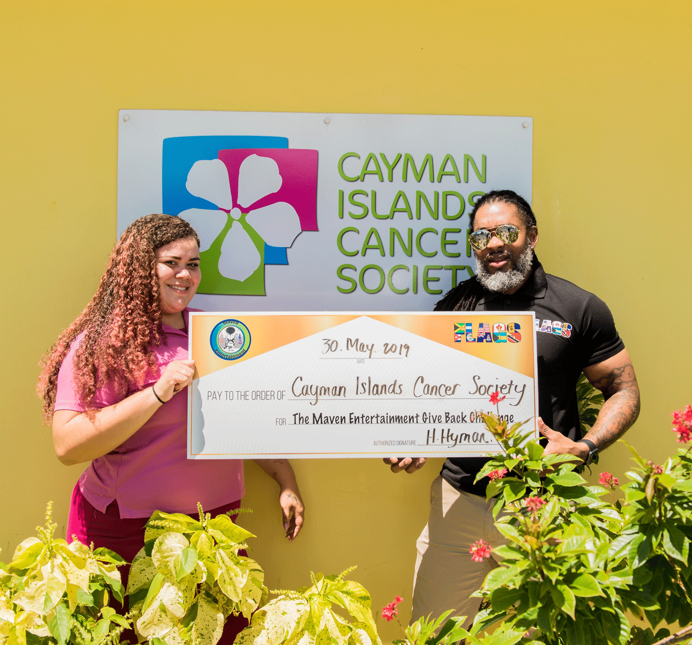Events company donates to 2 charities - Cayman Compass