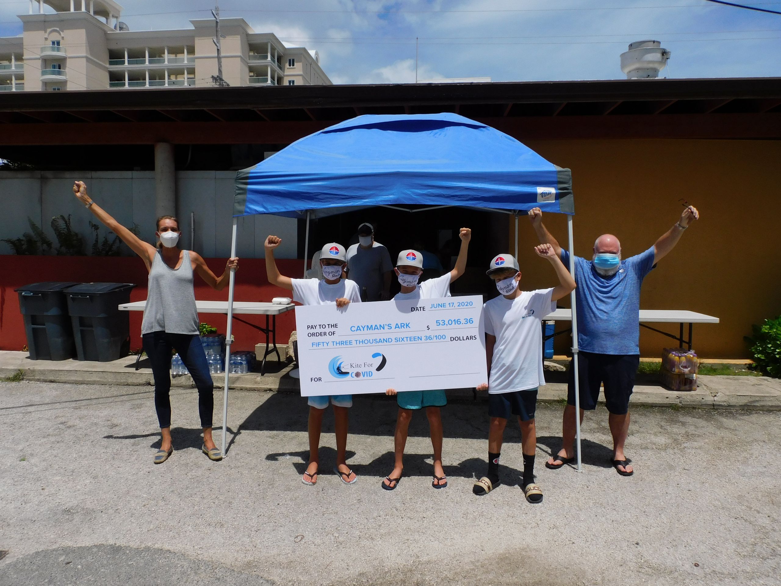 Kite for COVID trio presents cheque to ARK - Cayman Compass