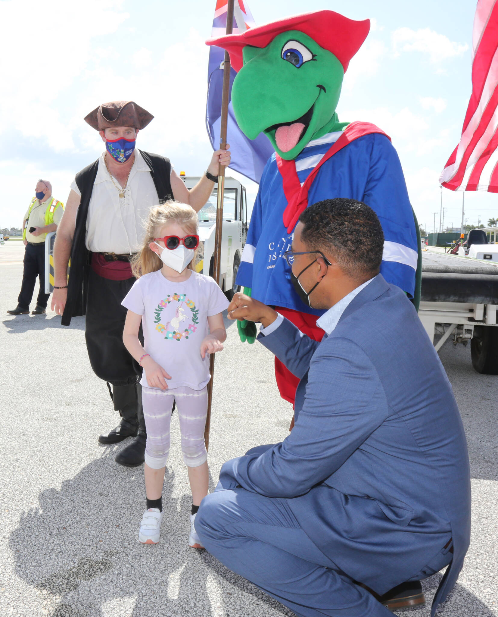 Minister & Sir Turtle greets child - Cayman Compass