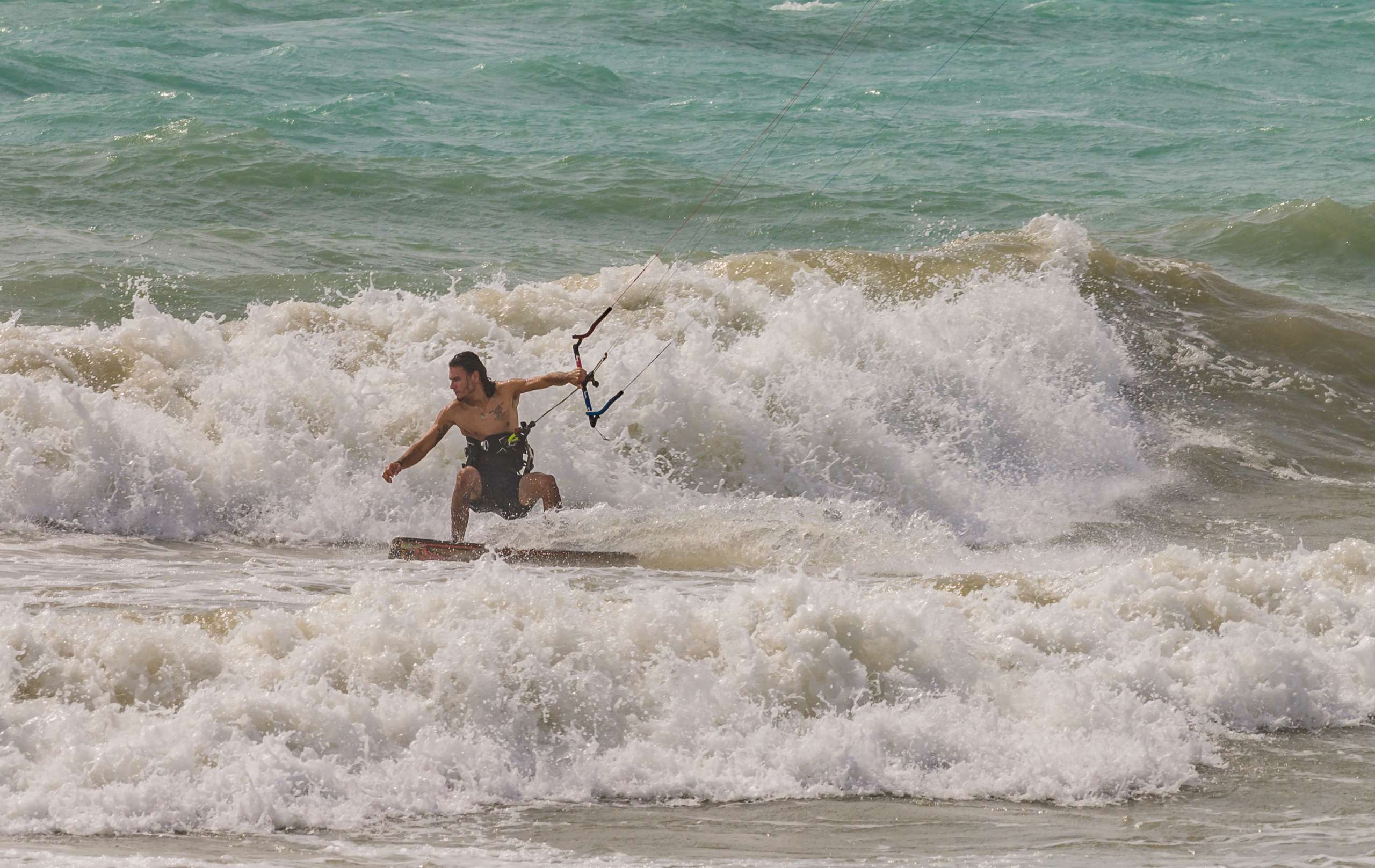 Surfers brave waves left by Ian - Cayman Compass