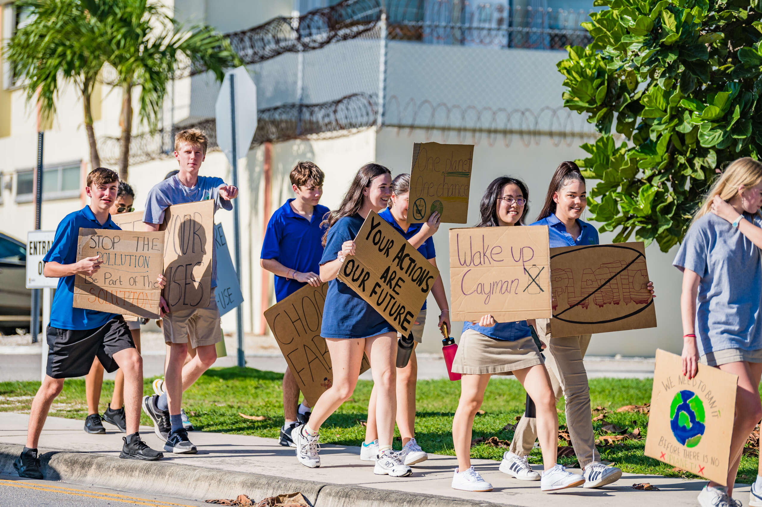 Students march in protest against single use plastics - Cayman Compass
