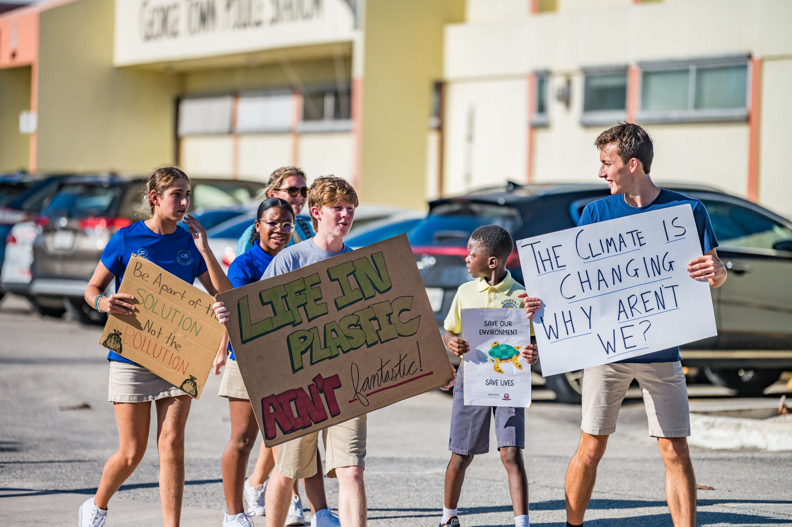 Students march in protest against single use plastics - Cayman Compass