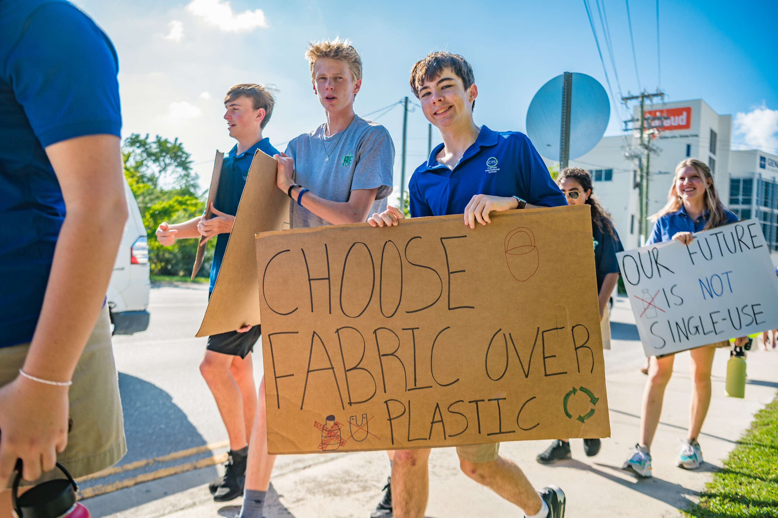Students march in protest against single use plastics - Cayman Compass