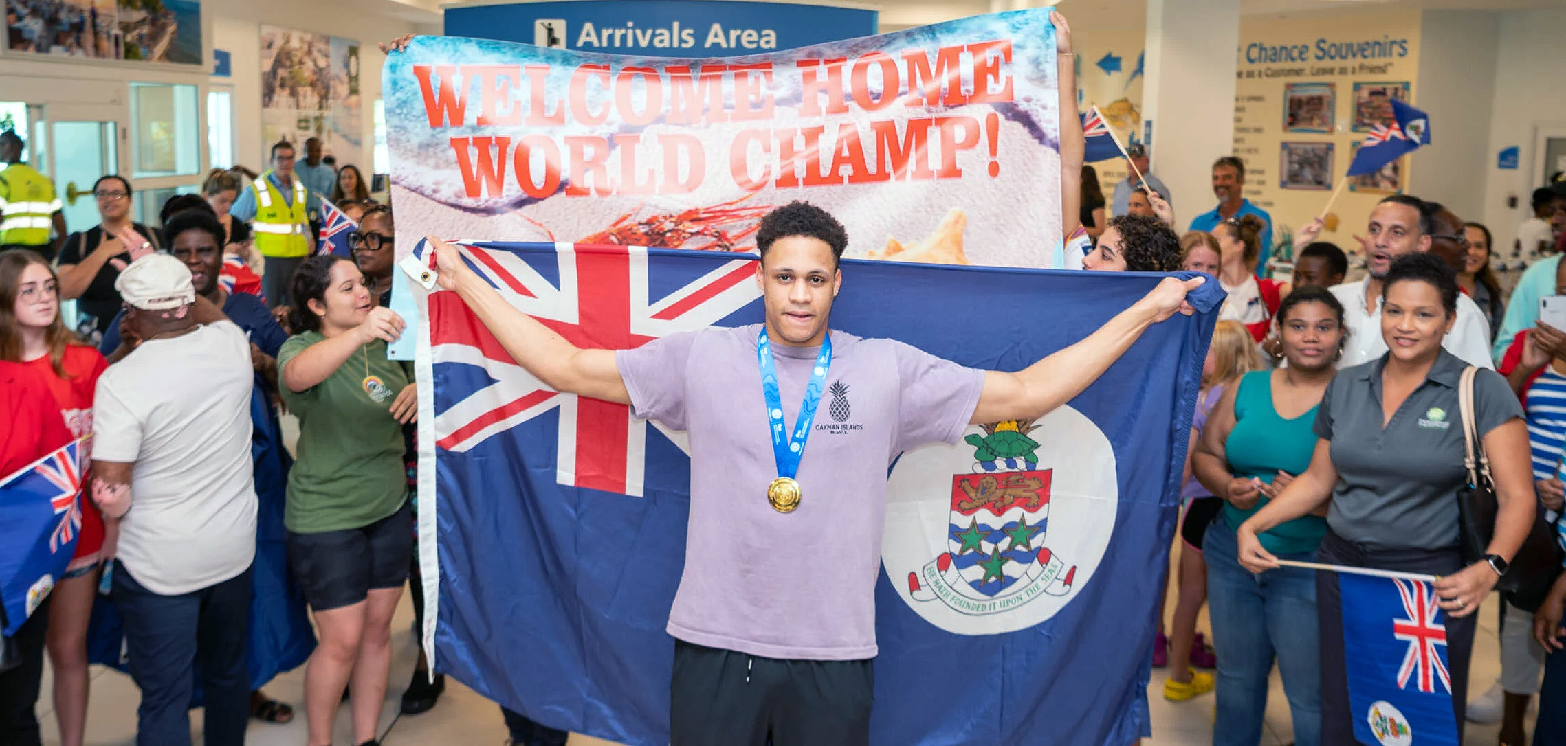 Cayman welcomes home golden swimmer Jordan Crooks - Cayman Compass